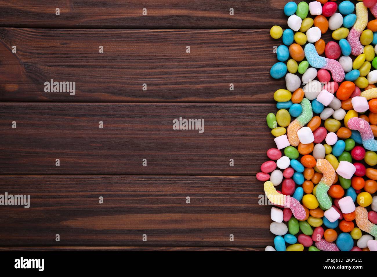 Colorful lollipops and different colored round candy on brown Stock ...