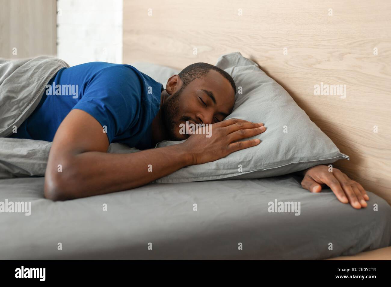Black Guy Sleeping Peacefully Lying In Bed In Modern Bedroom Stock ...