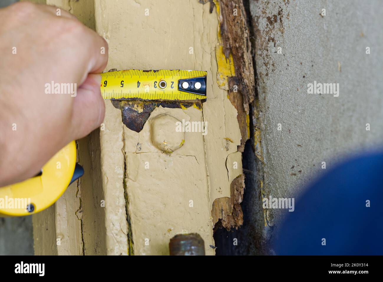 young master repairing old garage doors. handyman repairing a rotten ...