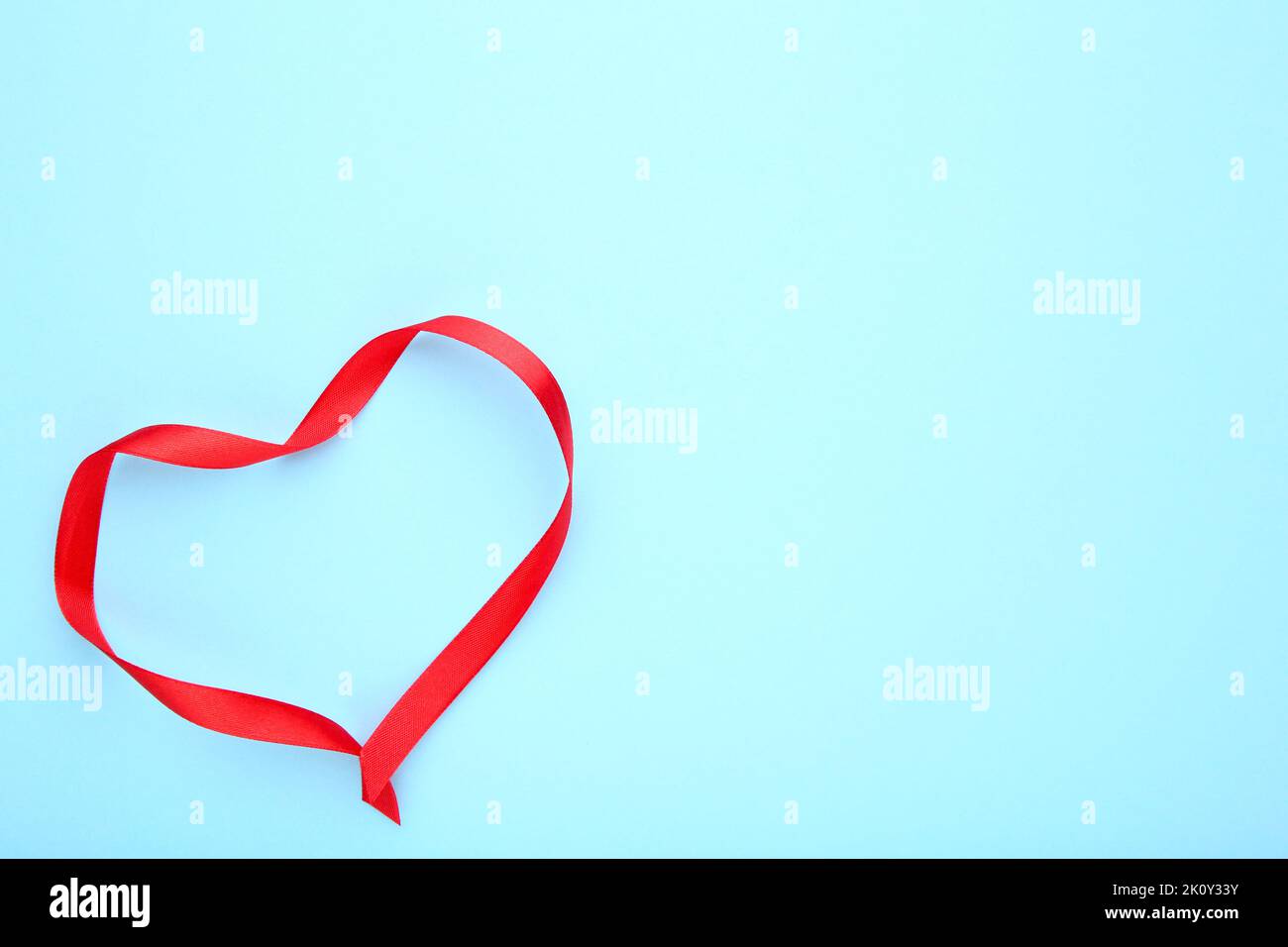 Ribbons shaped as hearts on blue, valentines day Stock Photo - Alamy
