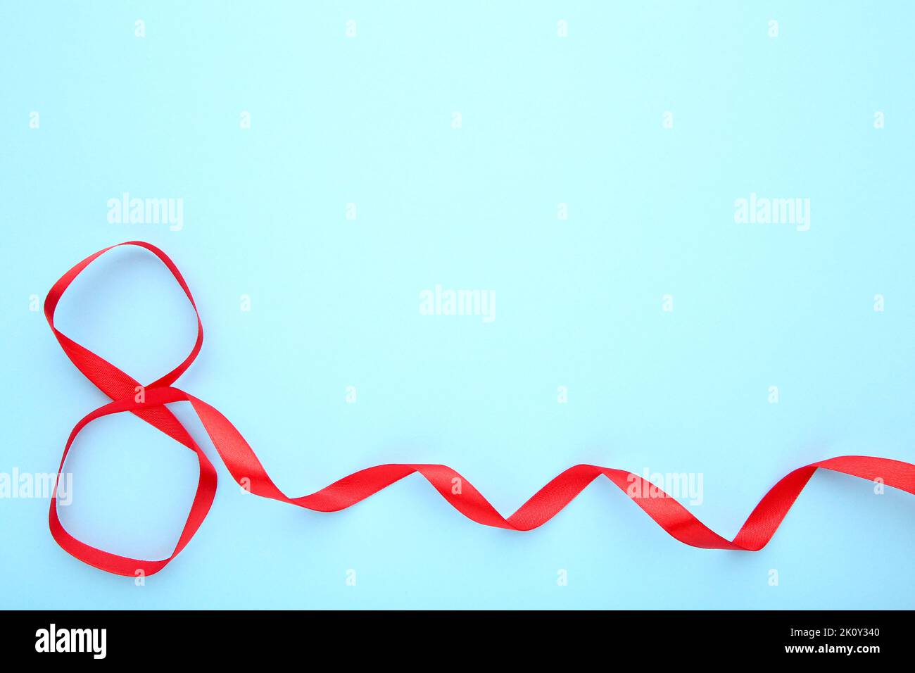 Ribbons shaped as 8 March on blue with copy space. International Women ...