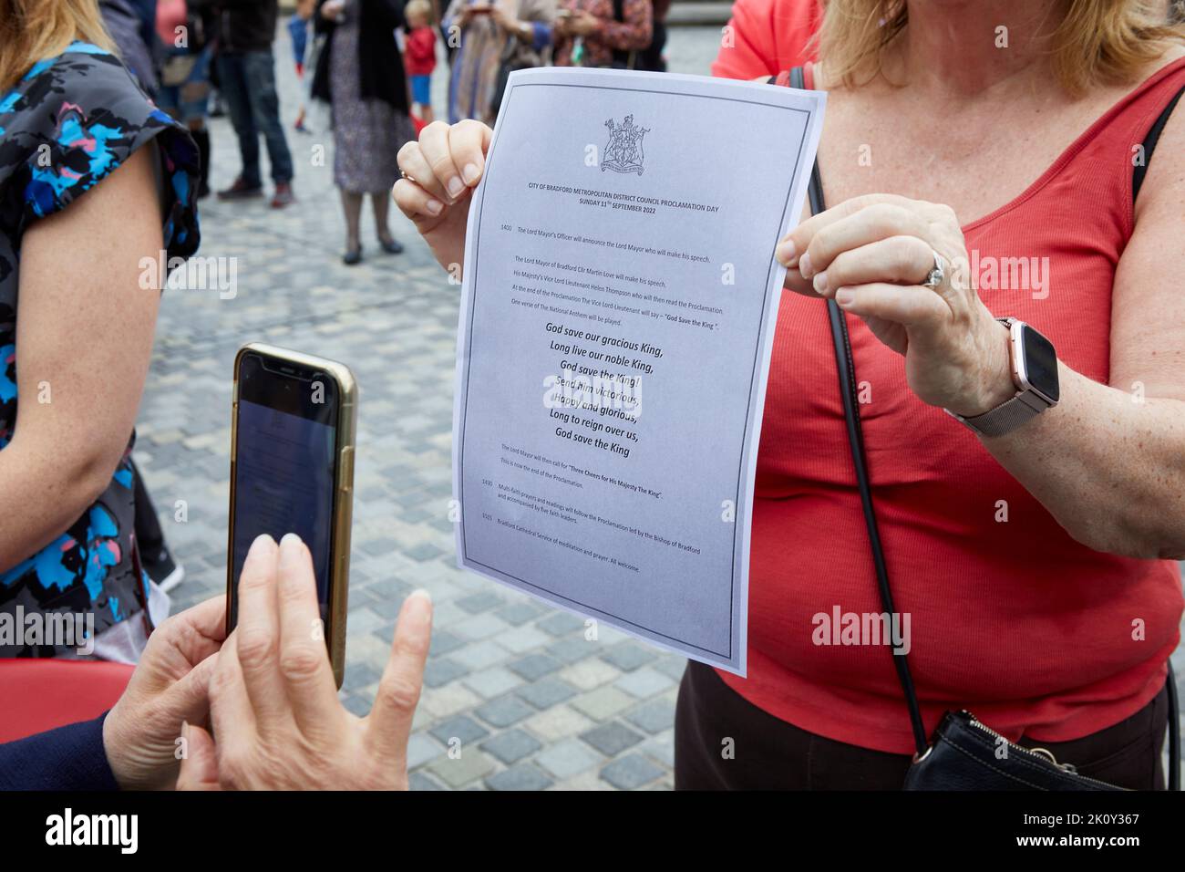 Woman takes photo with mobile phone of God Save the King King Charles ... Woman takes photo with mobile phone of God Save the King King Charles ...