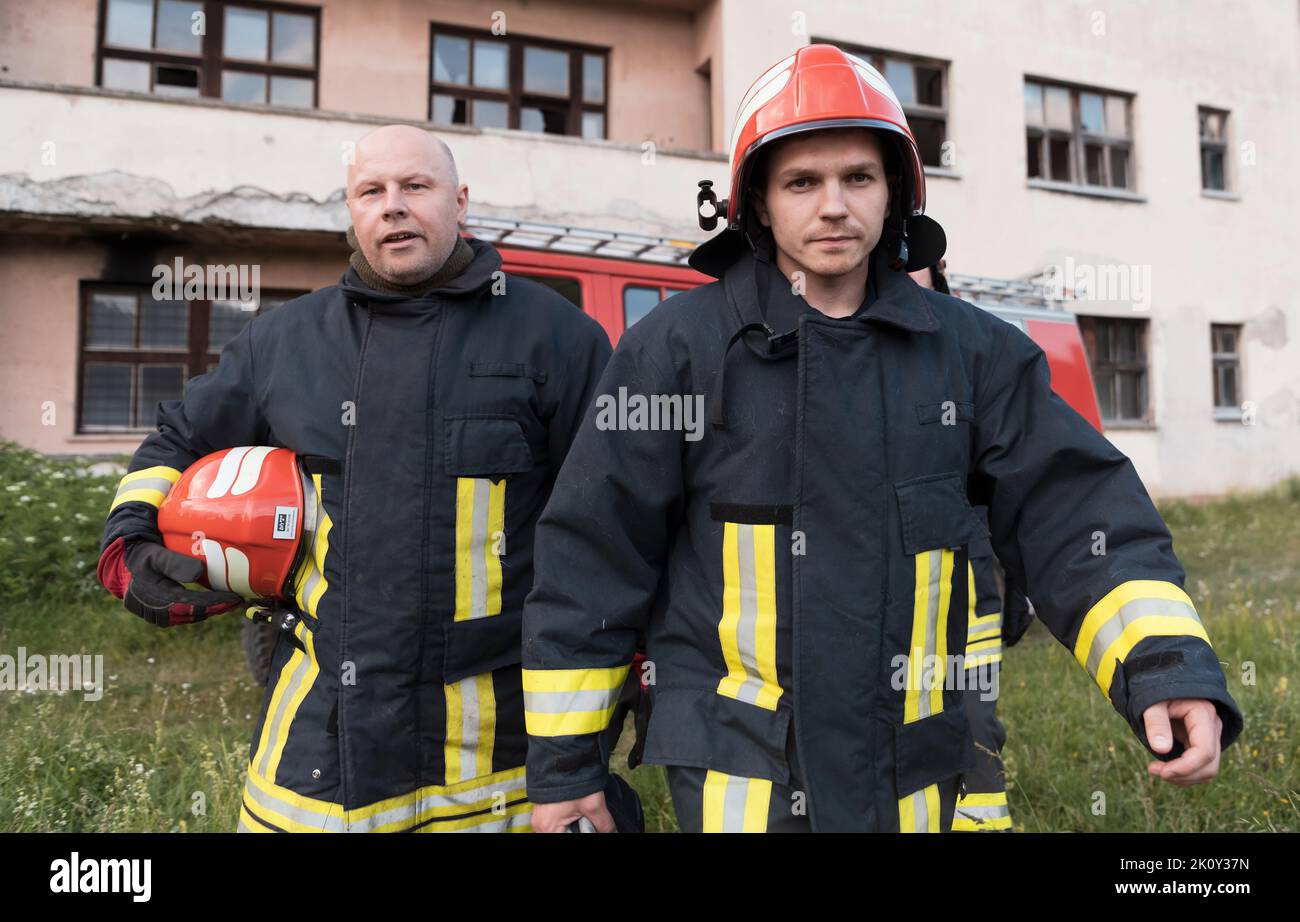 Group of fire fighters standing confident after a well done rescue ...