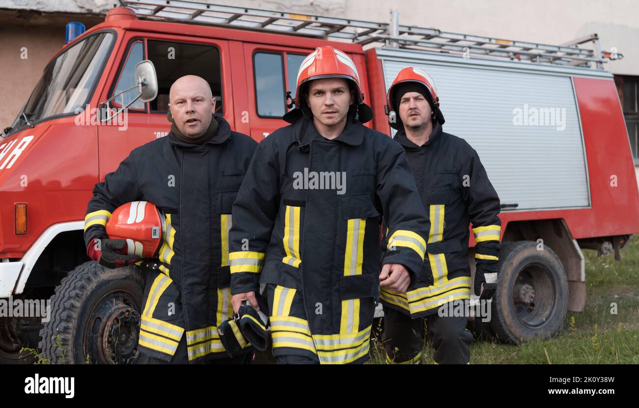 Group of fire fighters standing confident after a well done rescue ...