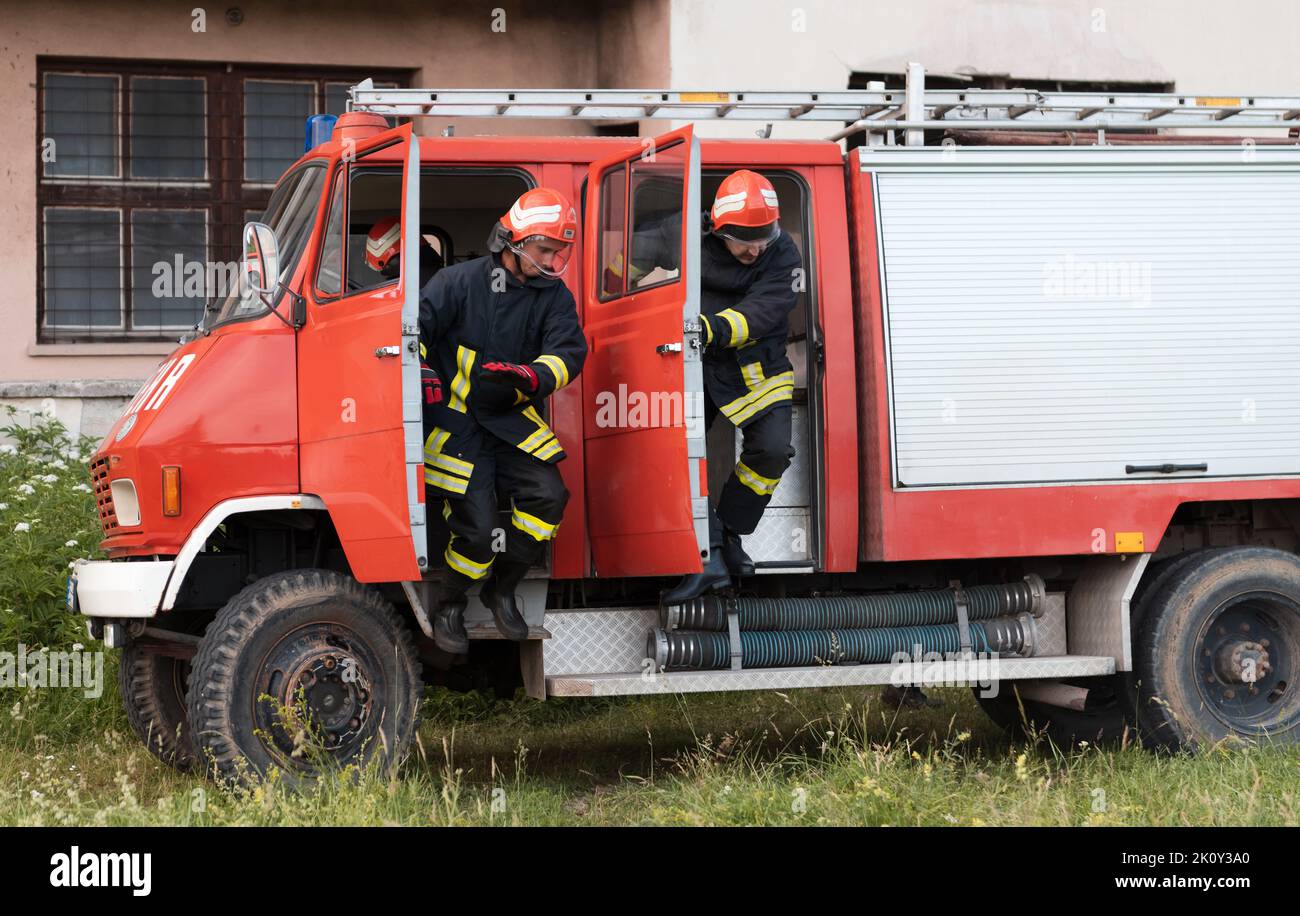 Group of fire fighters standing confident after a well done rescue ...