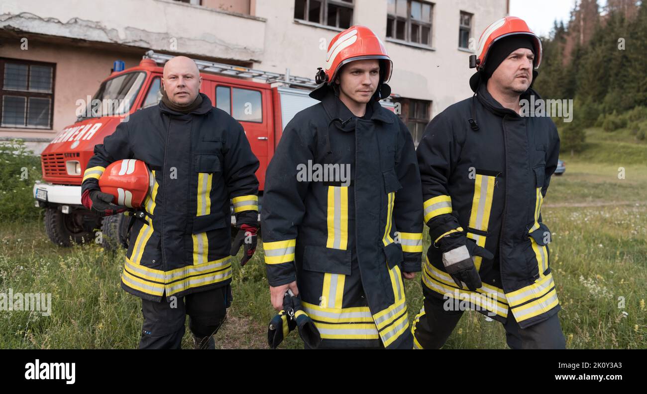 Group of fire fighters standing confident after a well done rescue ...