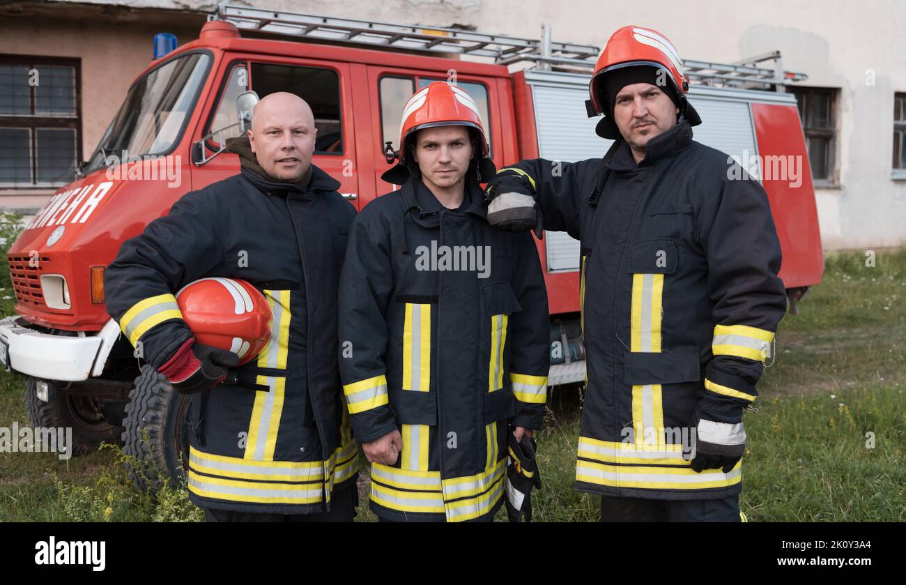 Group of fire fighters standing confident after a well done rescue ...