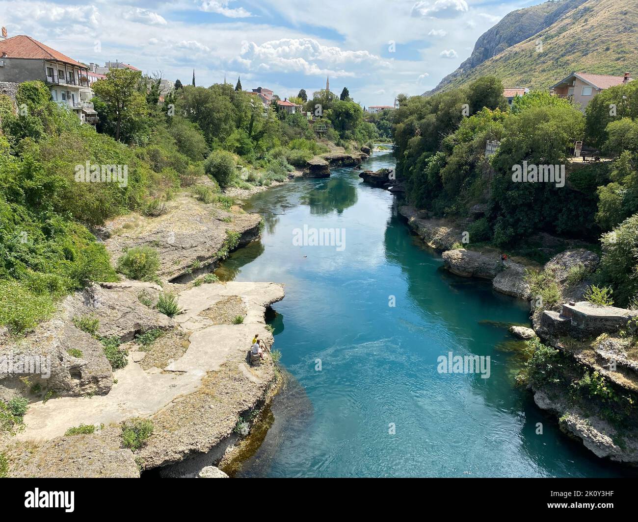 A scenic view of the river Neretva with greenery around, residential ...