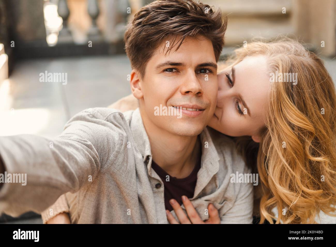 Guy kissing girlfriend on cheek hi-res stock photography and images - Alamy