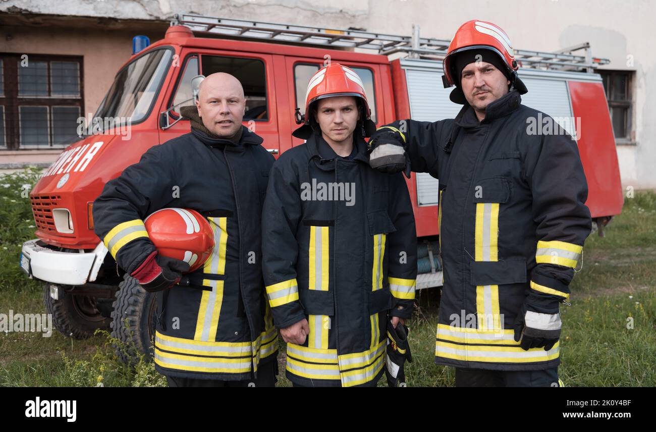 Group of fire fighters standing confident after a well done rescue ...