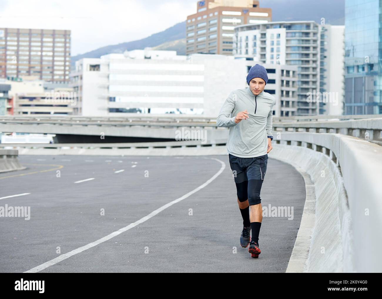 Running through the urban jungle. a young man jogging through empty ...