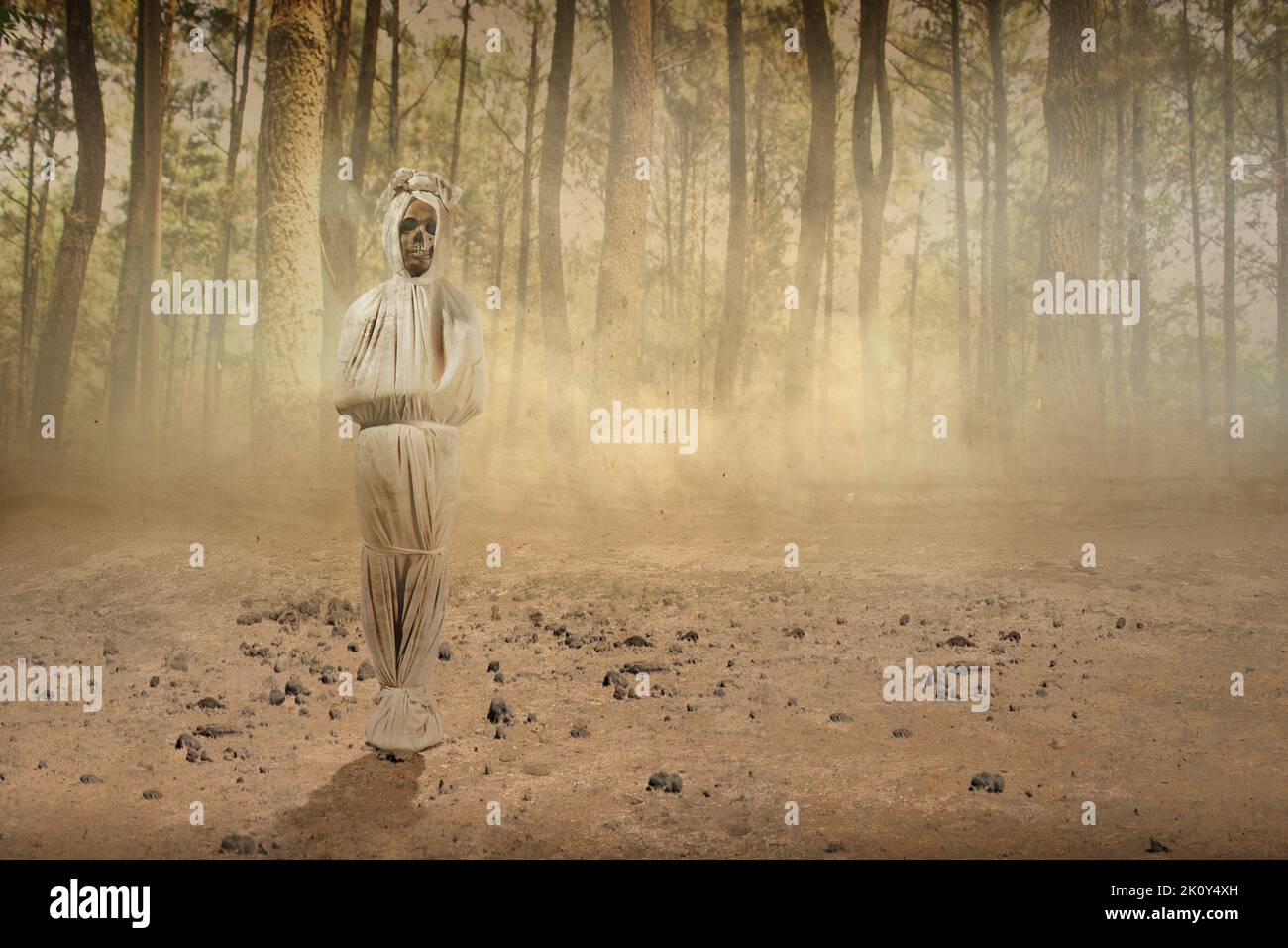Pocong is covered with a white linen shroud standing in a haunted ...