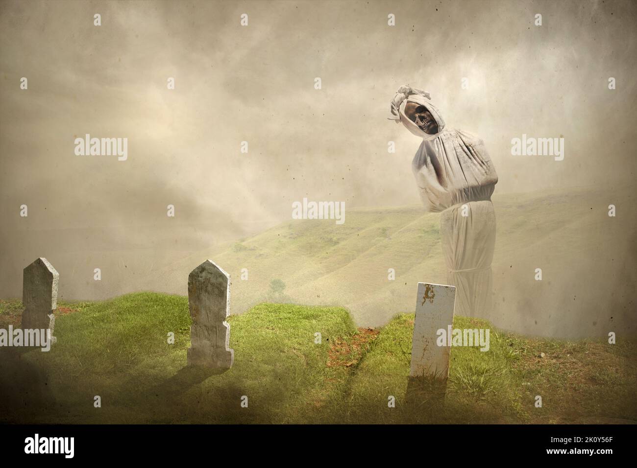 Pocong is covered with a white linen shroud standing in the cemetery ...