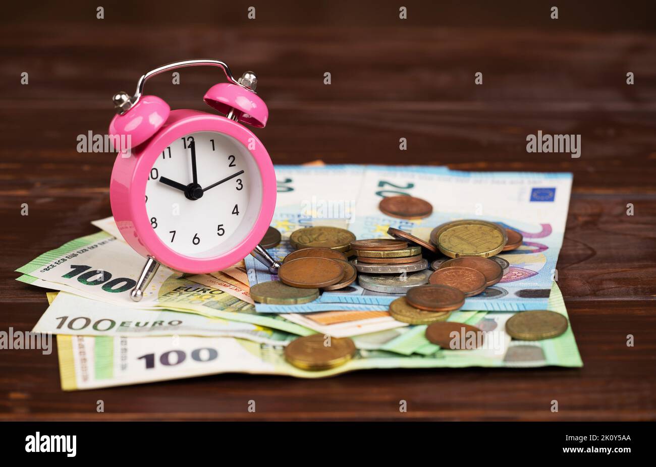 Alarm clock with euro money bills and coins. Saving energy, energy ...