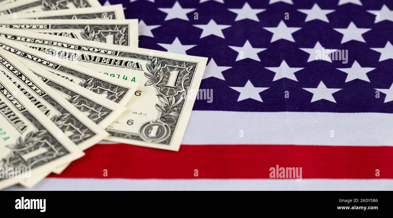 US dollar bills on a flag. Inflation, finance or money savings banner ...