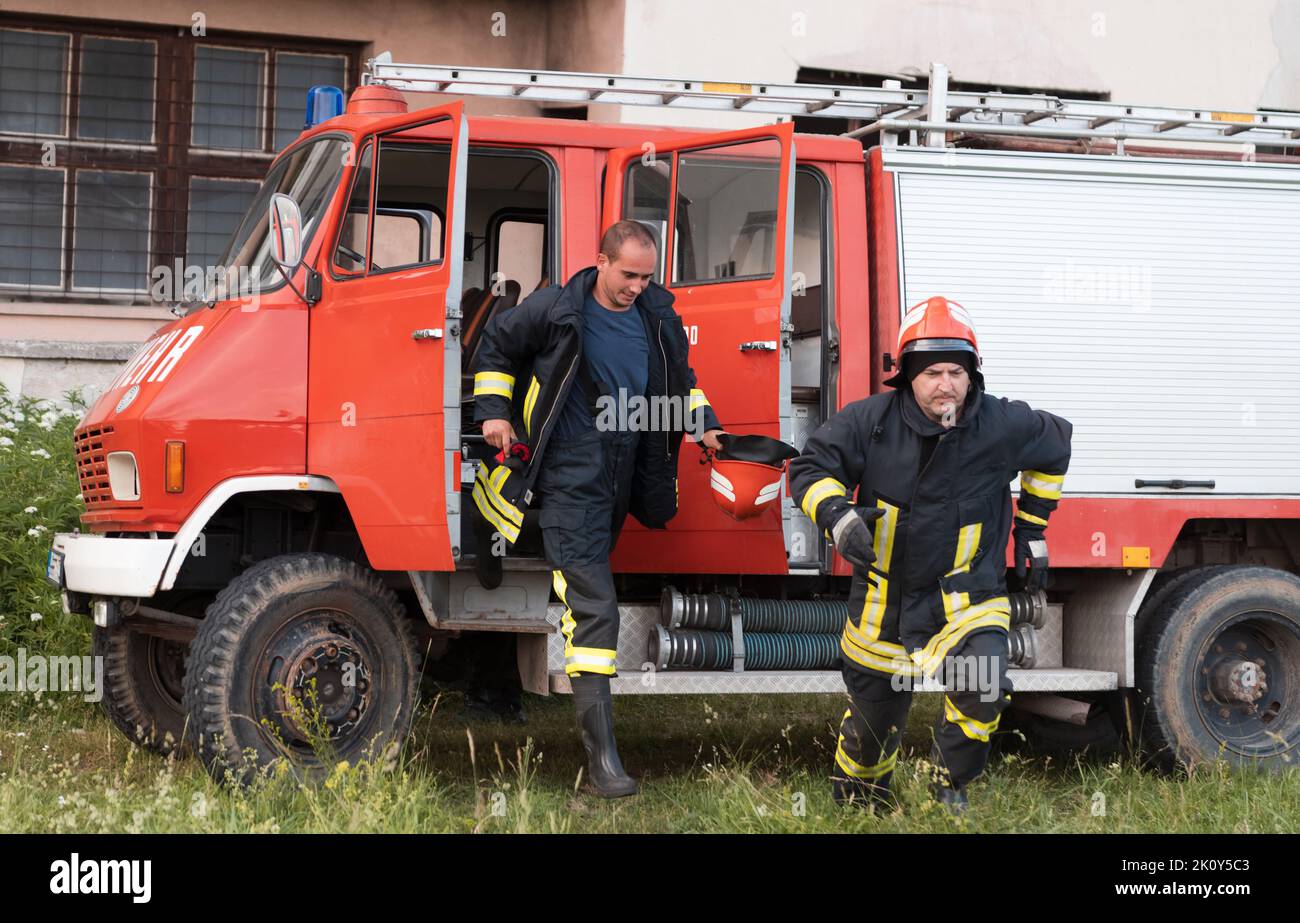 Group of fire fighters standing confident after a well done rescue ...