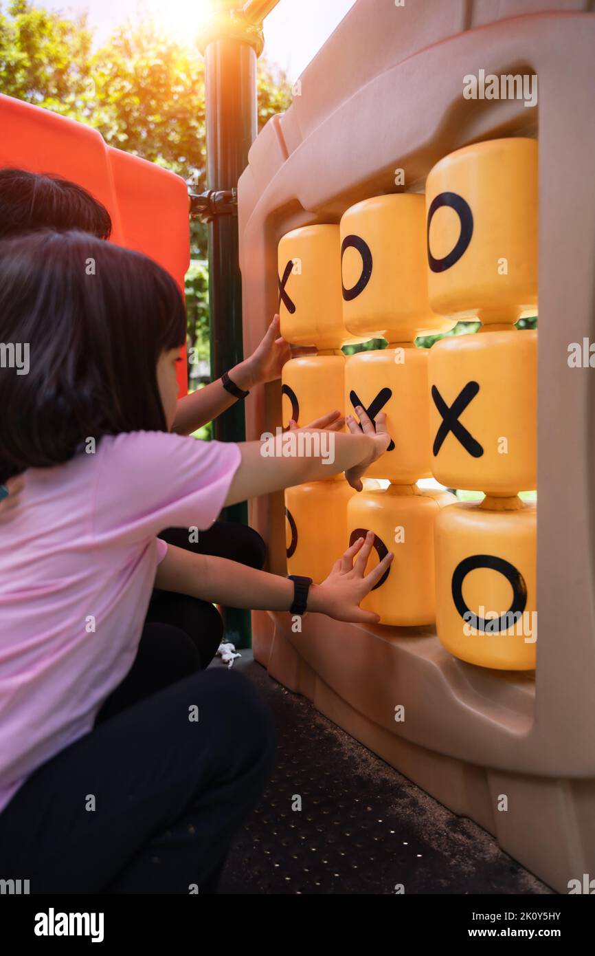 Child girl playing Tic-tac-toe game at the playground in park Stock ...