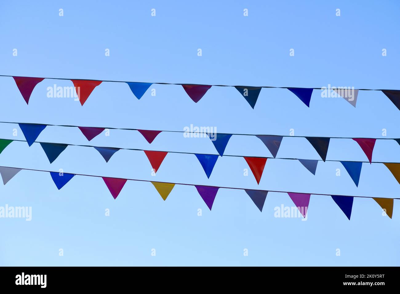 triangular colored pennant hanging in the air Stock Photo - Alamy