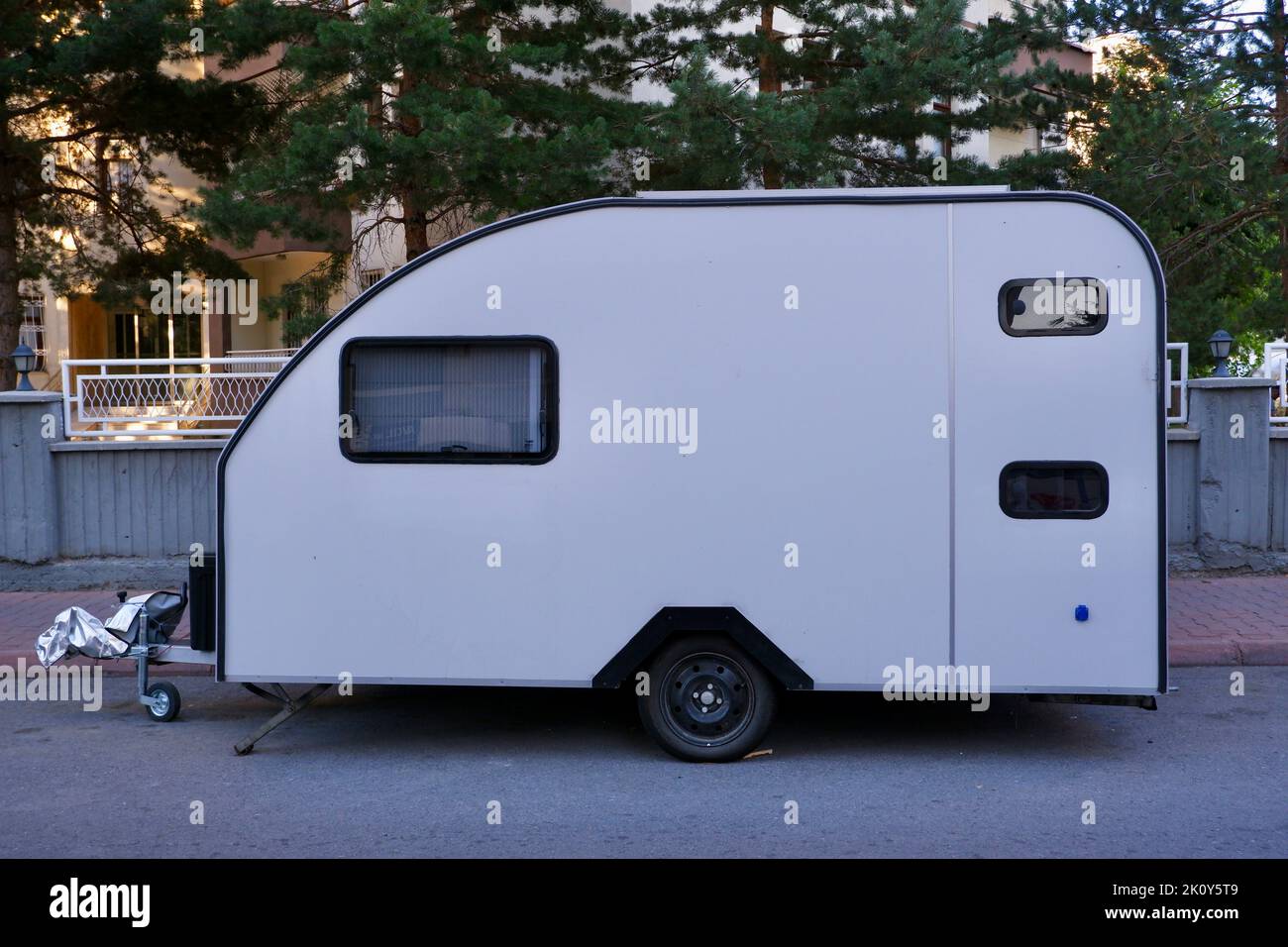 white caravan standing by the roadside Stock Photo - Alamy
