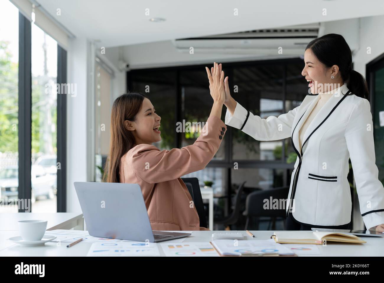 businesswomen giving hi five touching hands and thumb up during meeting for celebration business ...