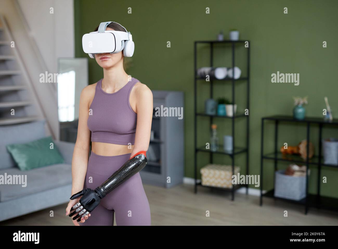 Young girl with disability using virtual reality glasses during sport ...