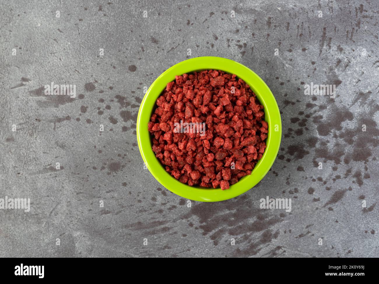 Overhead view of a green bowl filled with imitation bacon bits on a ...