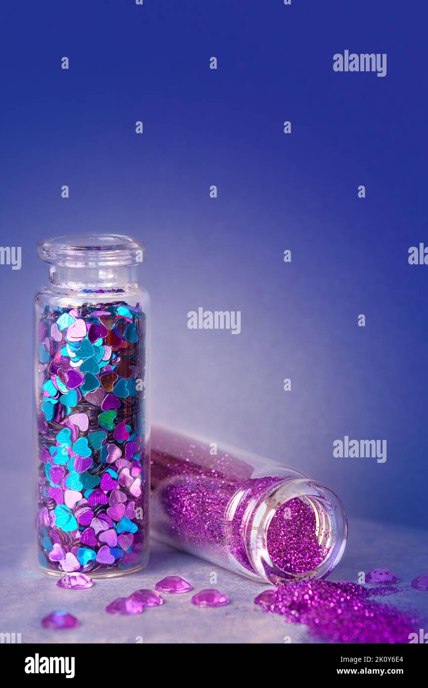 All kinds of glitter products on pink sparkling background. Close-up on ...