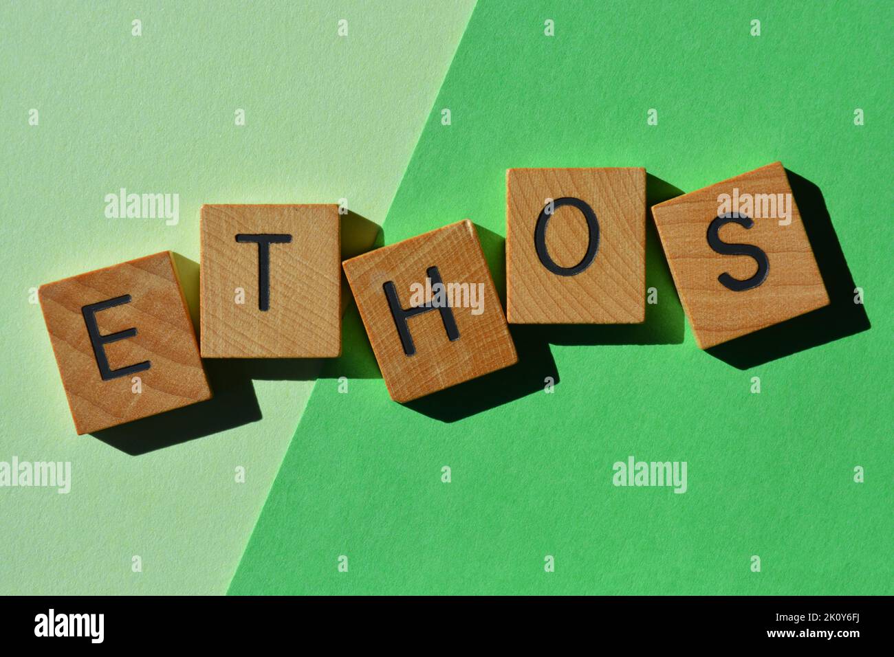 Ethos, word in wooden alphabet letters isolated on green background ...