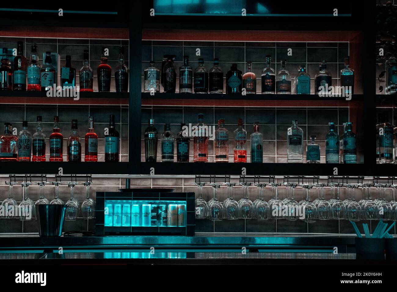 A bar stand with a variety of alcoholic drinks and empty glasses Stock ...