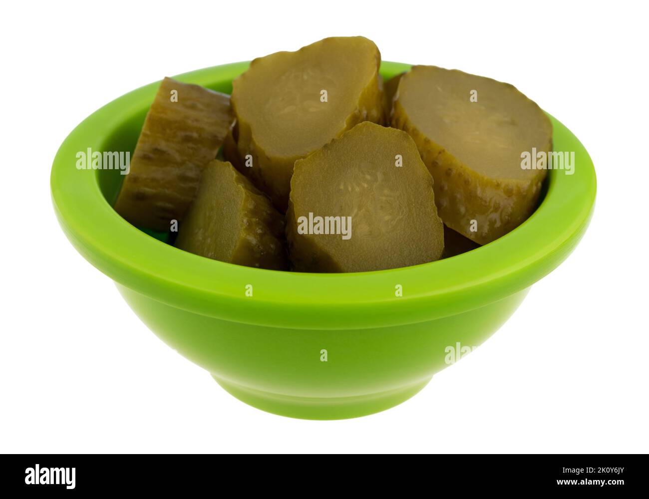 Side view of pickled cucumber slices in a green bowl isolated on a ...