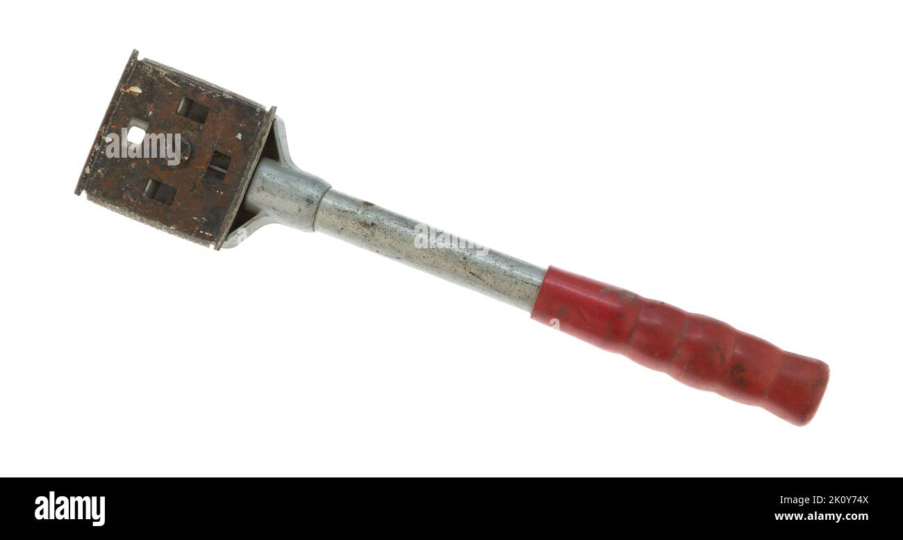 Old vintage aluminum paint scraper with a red handle isolated on a ...