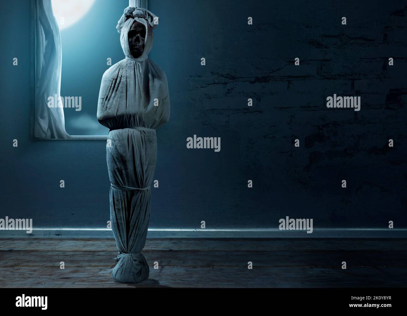 Pocong is covered with a white linen shroud standing on an abandoned ...