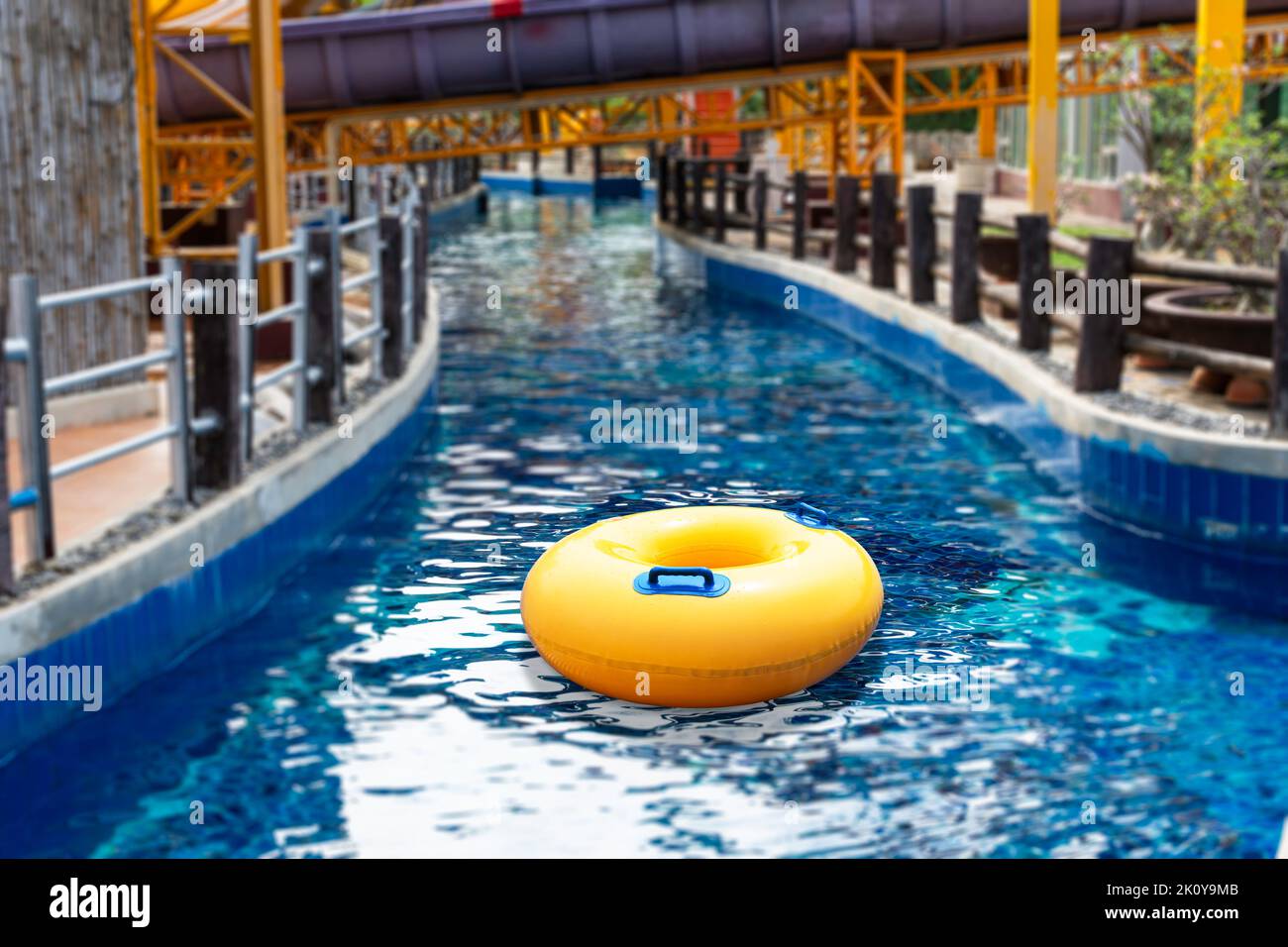 Yellow ring floating in a blue wave water on the canal in swimming pool ...