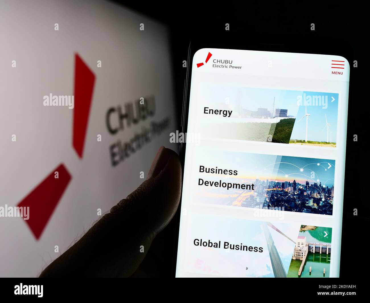 Person holding smartphone with website of Japanese company Chubu ...