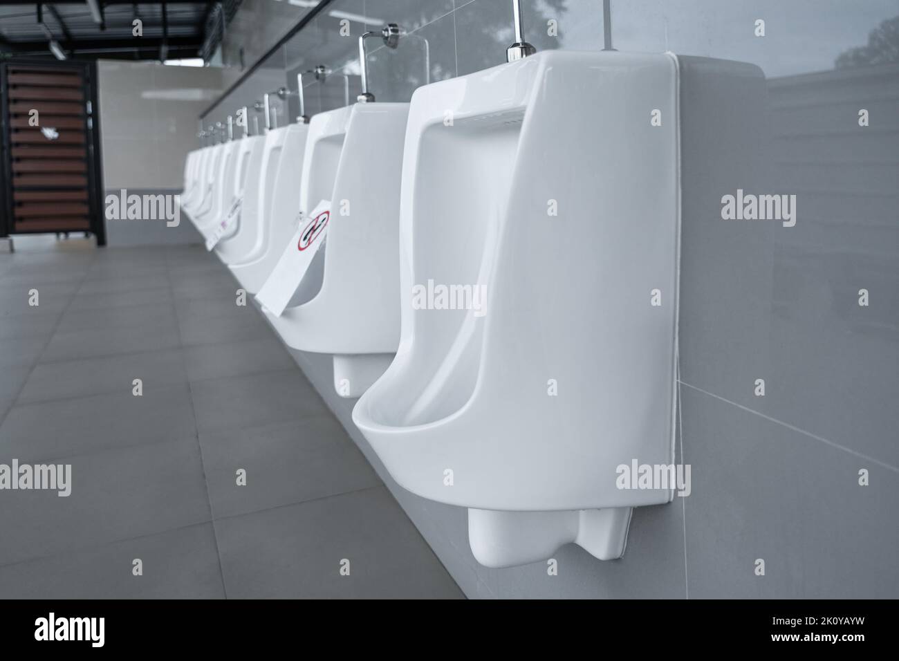 Closeup of white urinals in men's bathroom. Ceramic urinals in public ...
