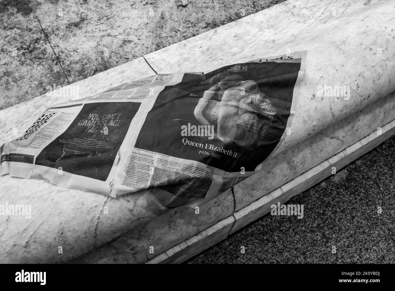 A newspaper on the Victoria Memorial outside Buckingham Palace, the day ...