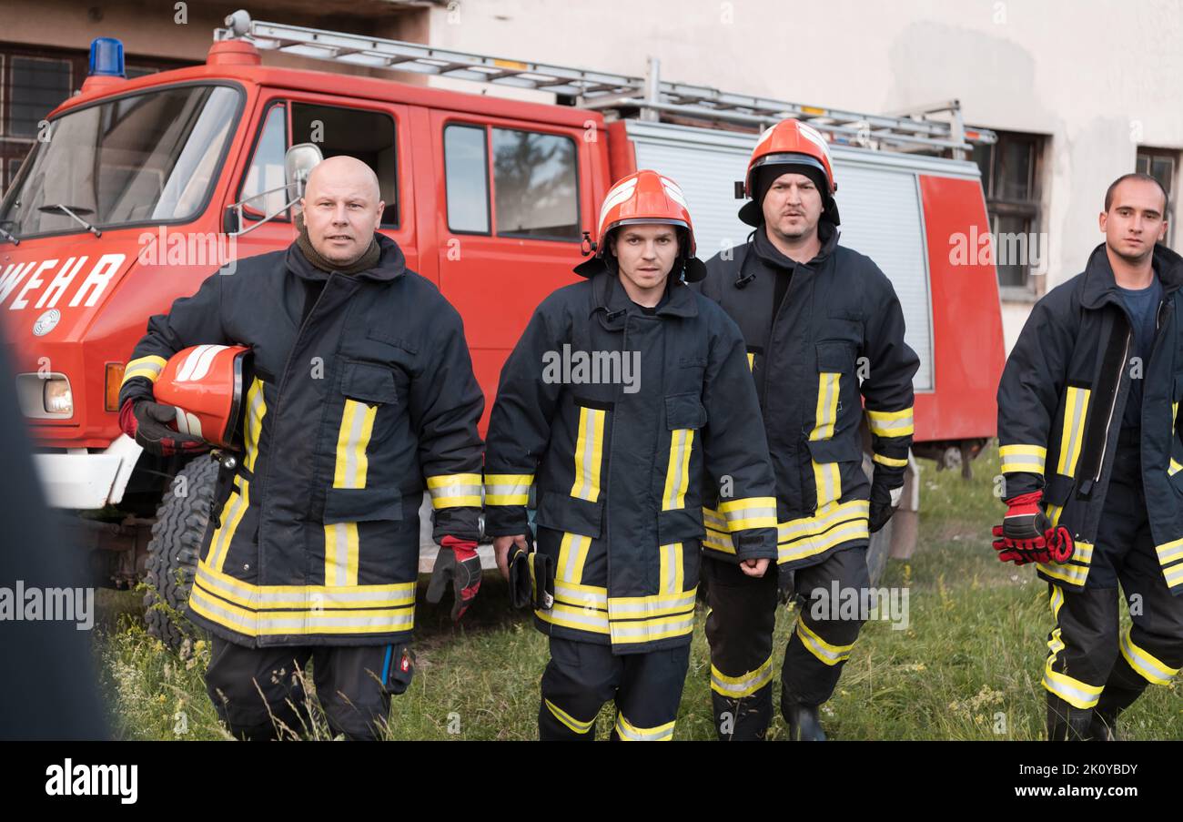 Group of fire fighters standing confident after a well done rescue ...