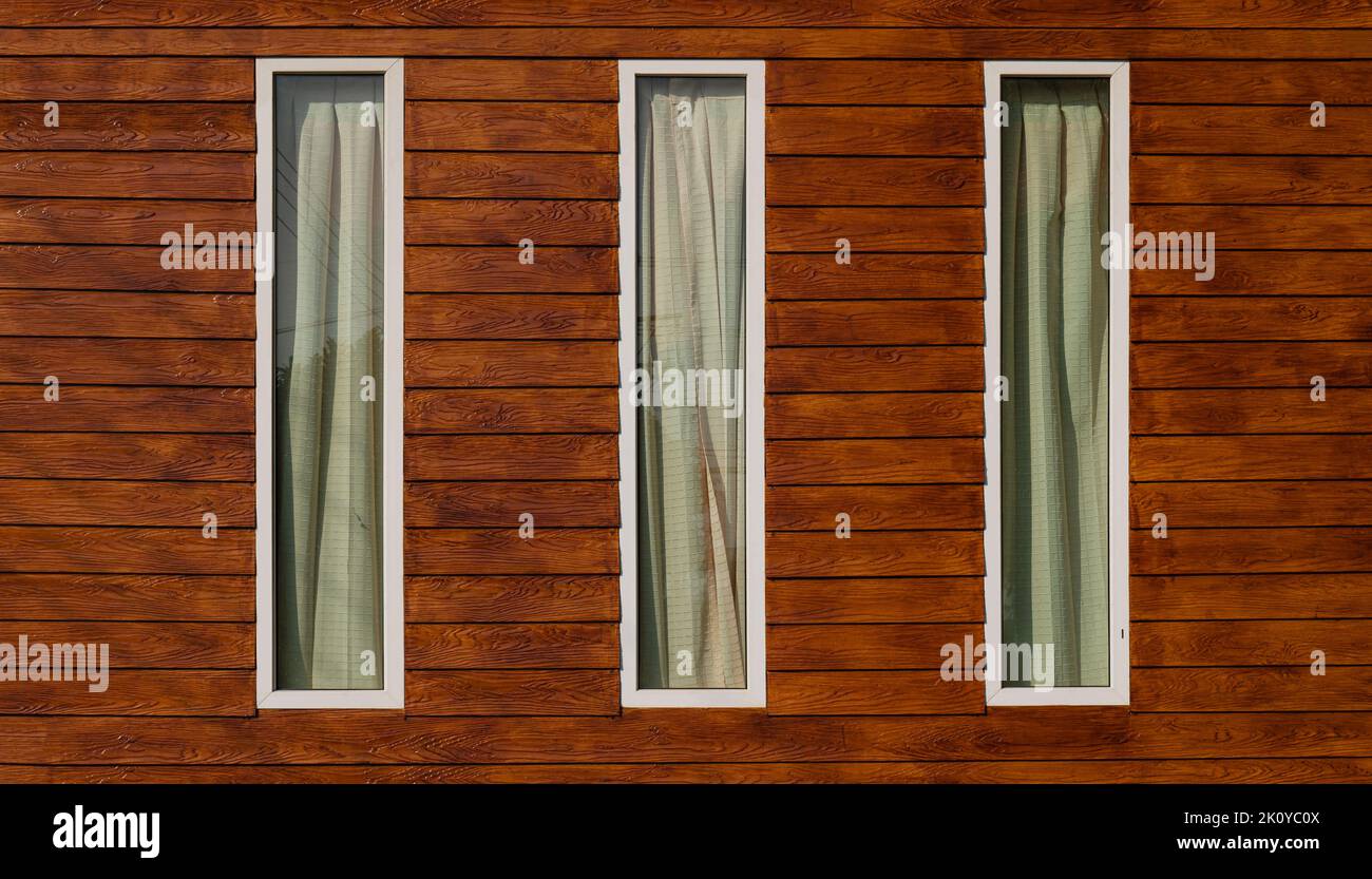 Three windows on wood wall with curtain, outdoor view. Window from ...
