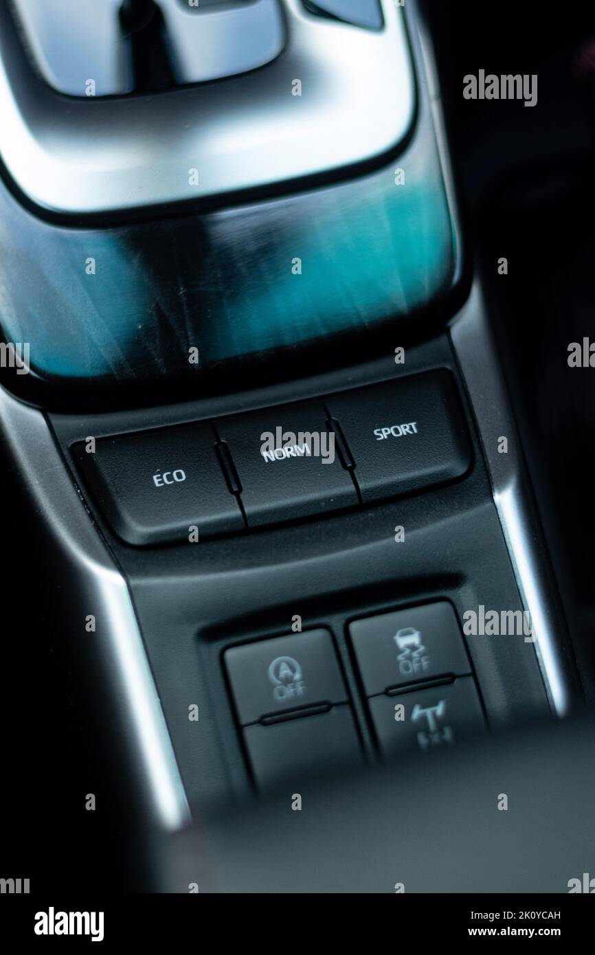 A photo of three switches inside a car showing eco mode, normal mode ...