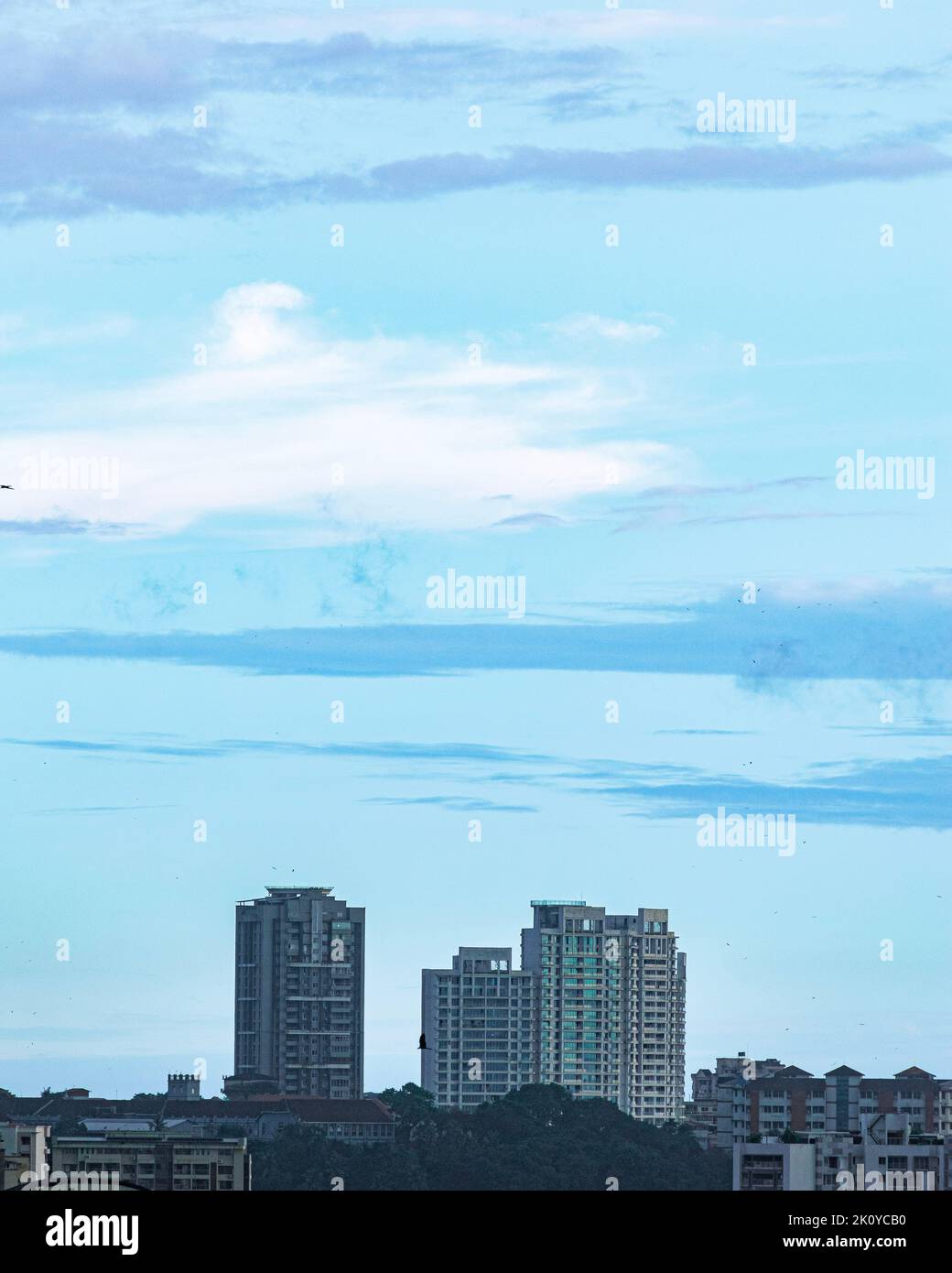 A picture of few buildings under construction and the wide blue sky ...