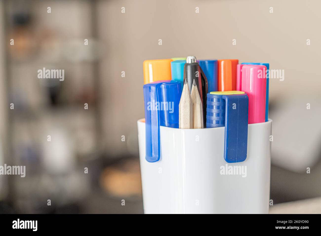 Collection of pens, pencils and markers in a cup Stock Photo - Alamy
