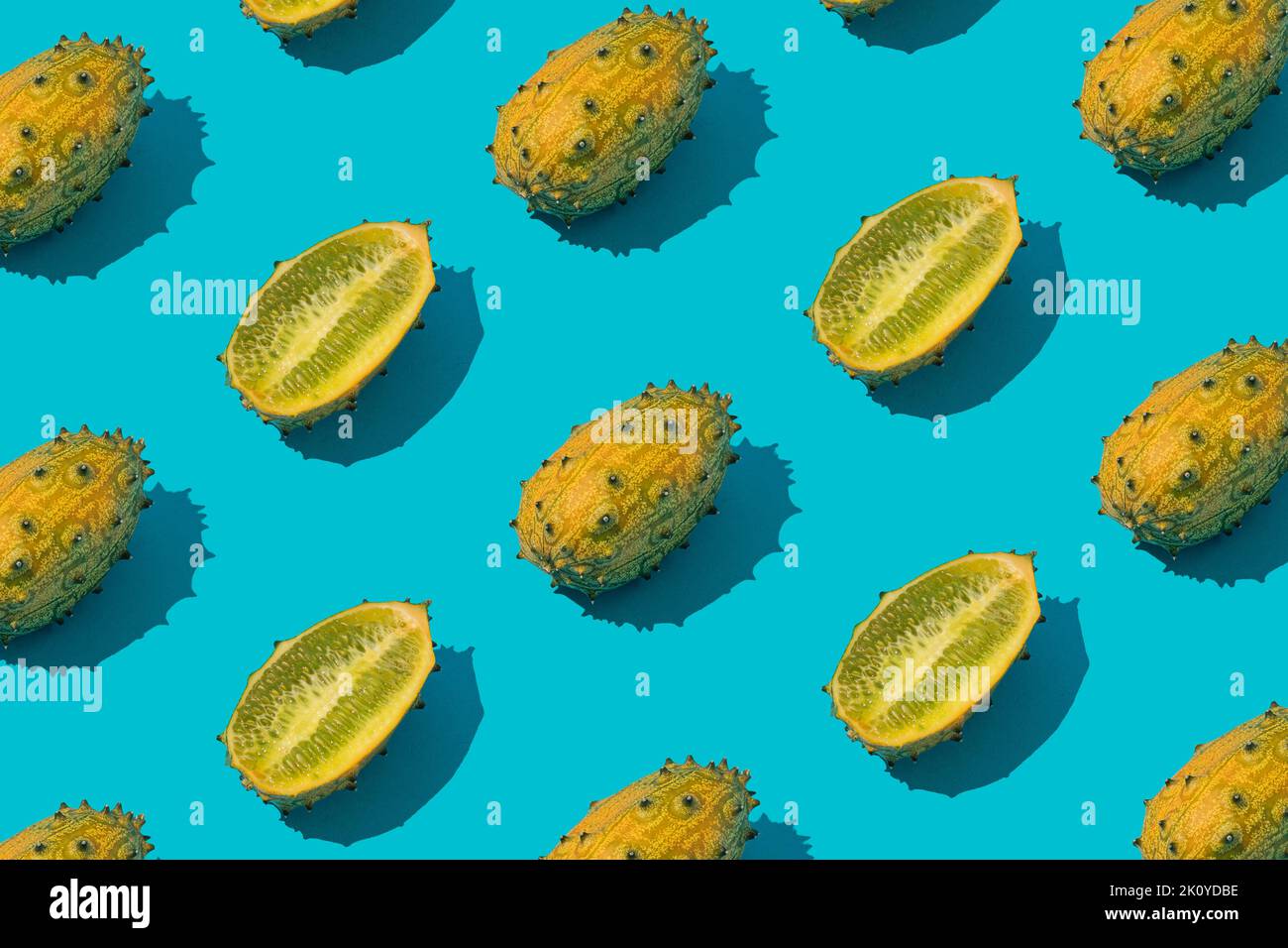 Fresh kiwano fruit, jelly melon, horned melon pattern on blue ...
