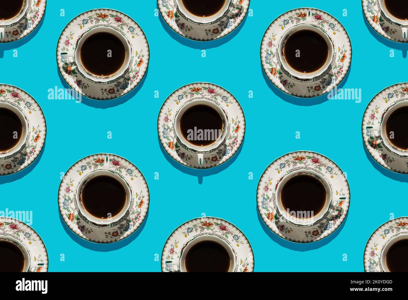 Coffee in vintage and antique floral china cups pattern on blue ...