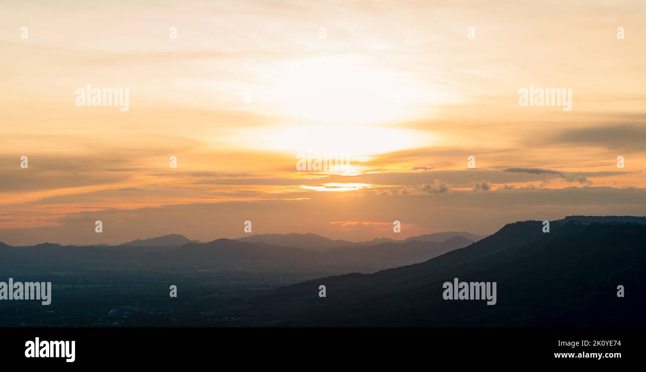 Landscape of mountain range with sunset sky. Mountain at dusk. Orange ...