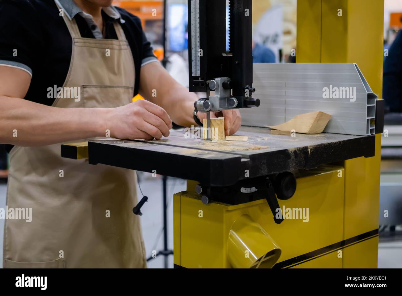 Professional man carpenter using electric bandsaw tool Stock Photo - Alamy
