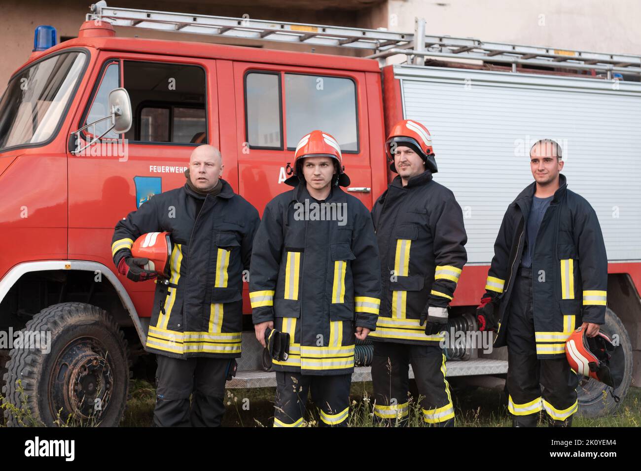 Group of fire fighters standing confident after a well done rescue ...