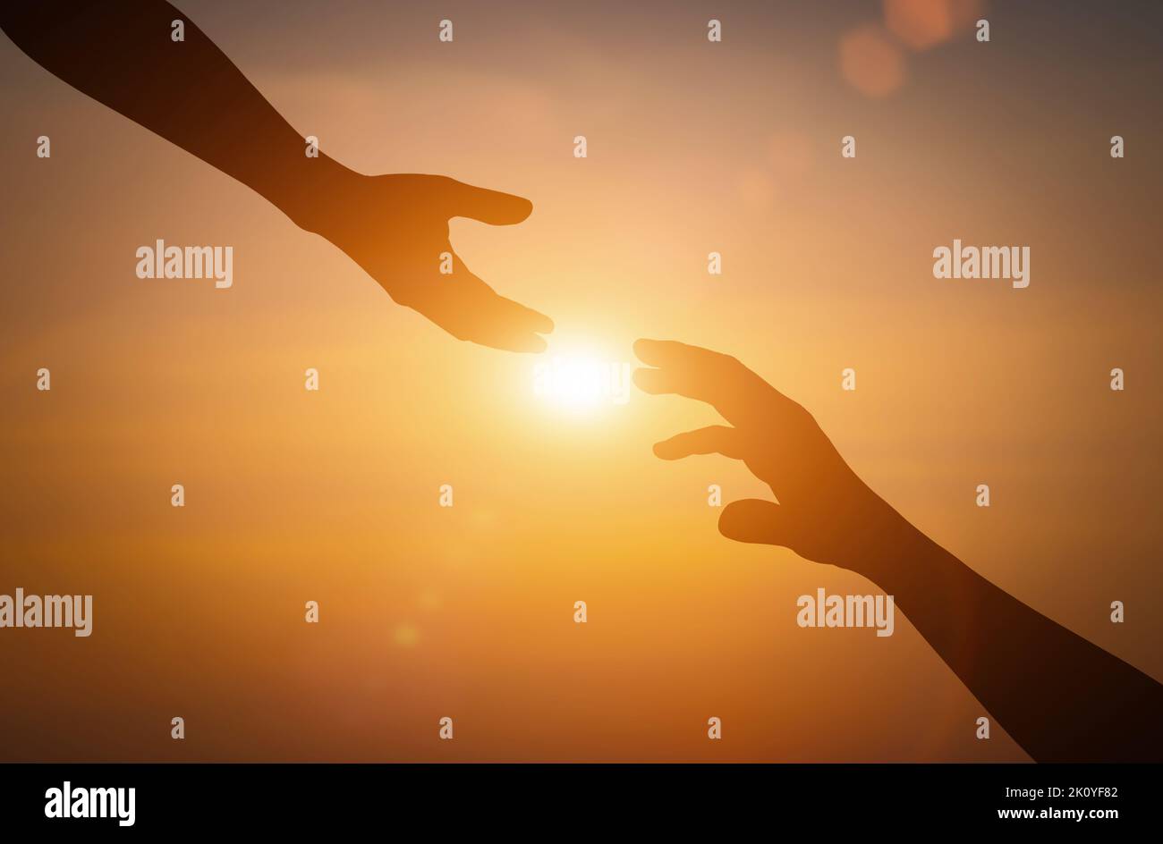Silhouette of reaching, giving a helping hand, hope and support each ...