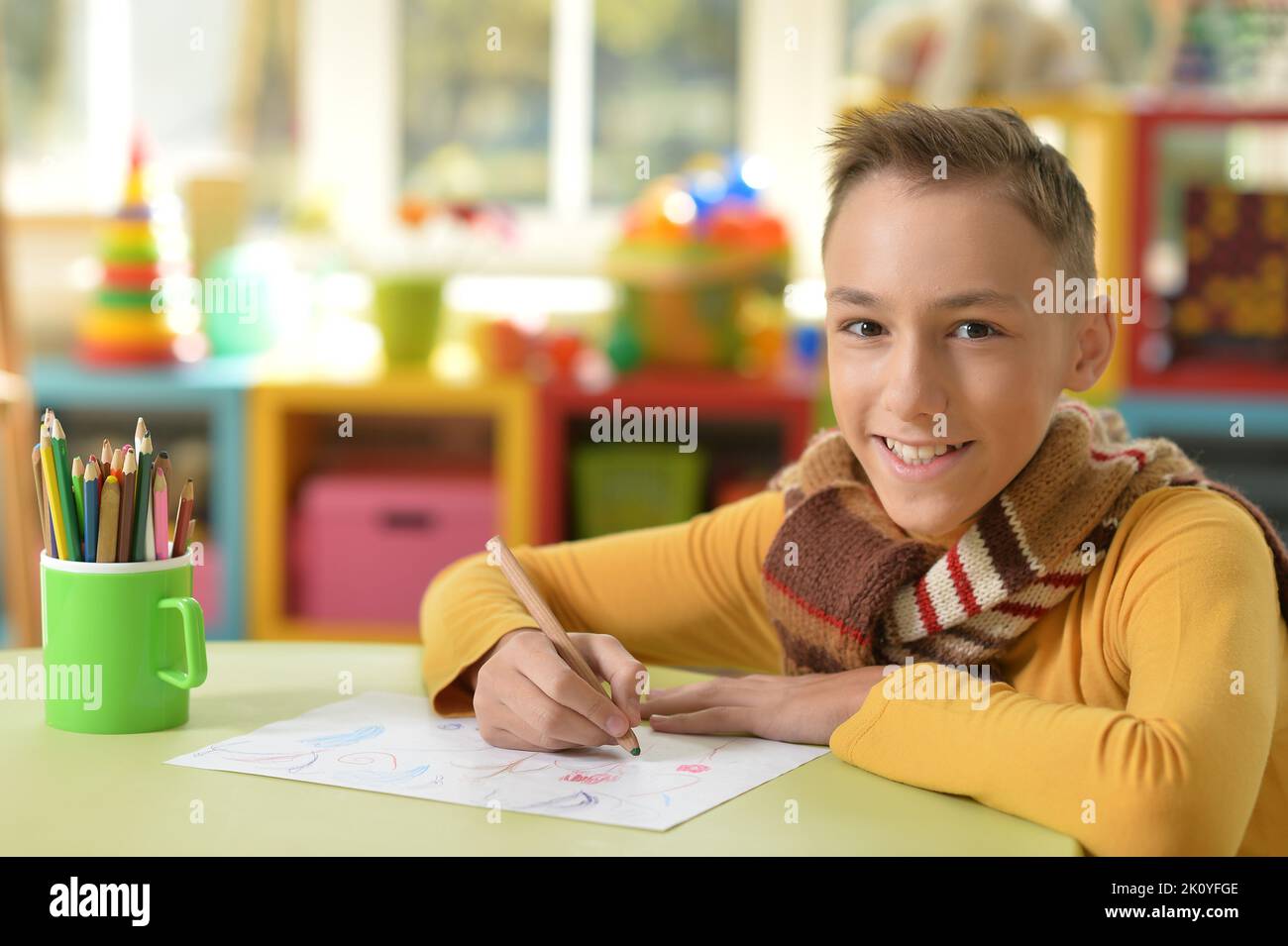 Boy draws at the table in the room Stock Photo - Alamy