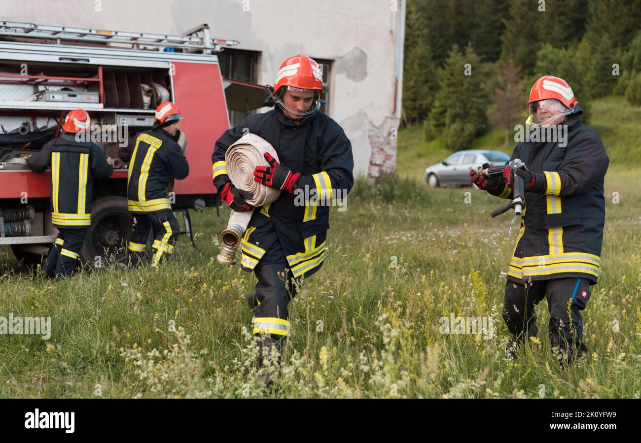 Group of fire fighters standing confident after a well done rescue ...