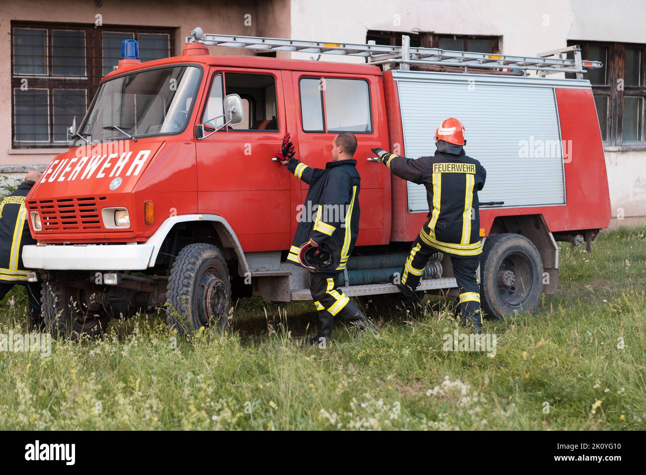 Group of fire fighters standing confident after a well done rescue ...
